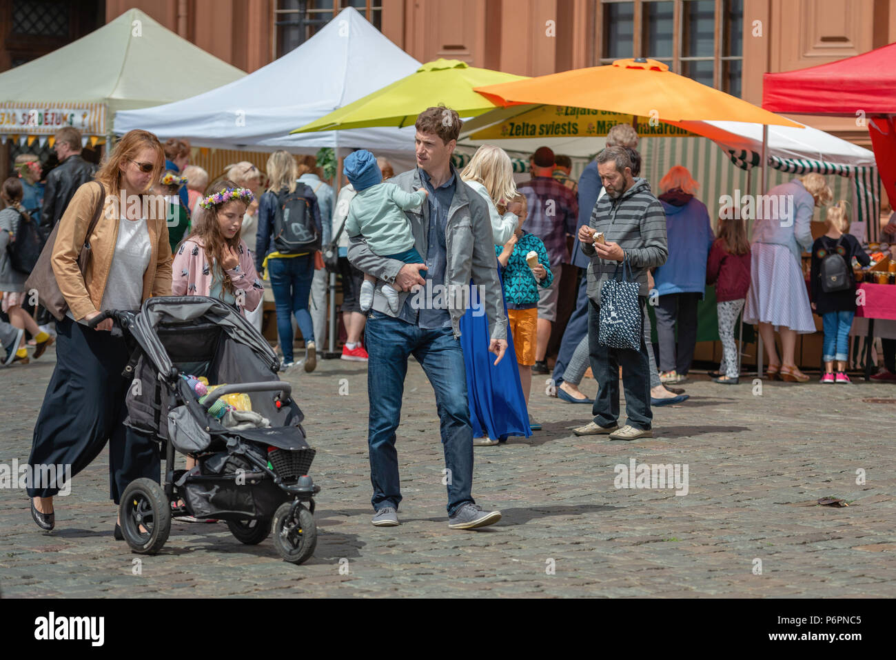 RIGA, LATVIA - JUNE 22, 2018: Summer solstice market. Family with ...