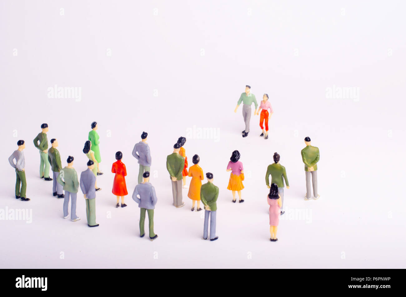 The crowd looks at the man and woman who comes towards her on a white ...