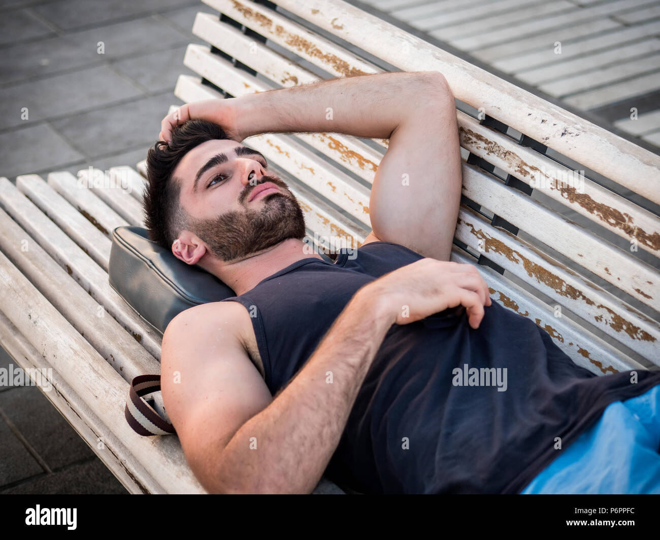 Young man sleeping on bench hi-res stock photography and images - Alamy
