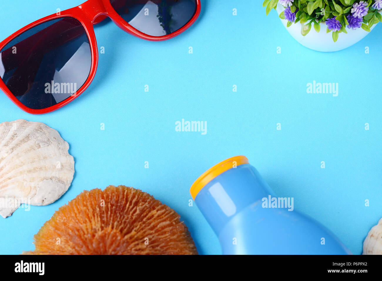 Top view of sunglasses, shells, starfish and sunblock. Summer concept ...