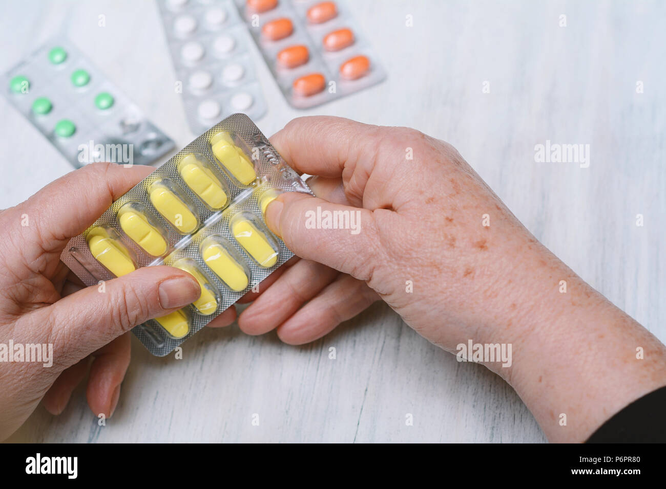 Old man holding tablet of pill. Medicine concept Stock Photo - Alamy