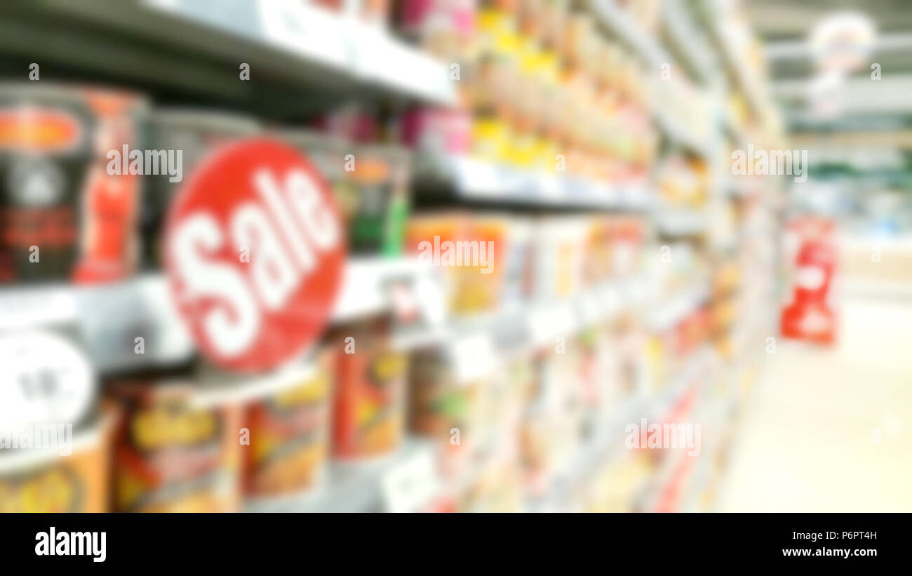 Abstract blur of aisle in supermarket with customers and department ...