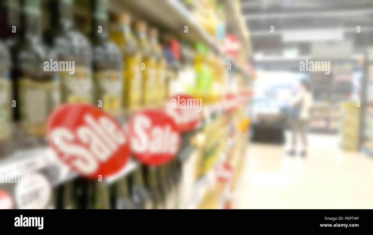 Abstract blur of aisle in supermarket with customers and department ...