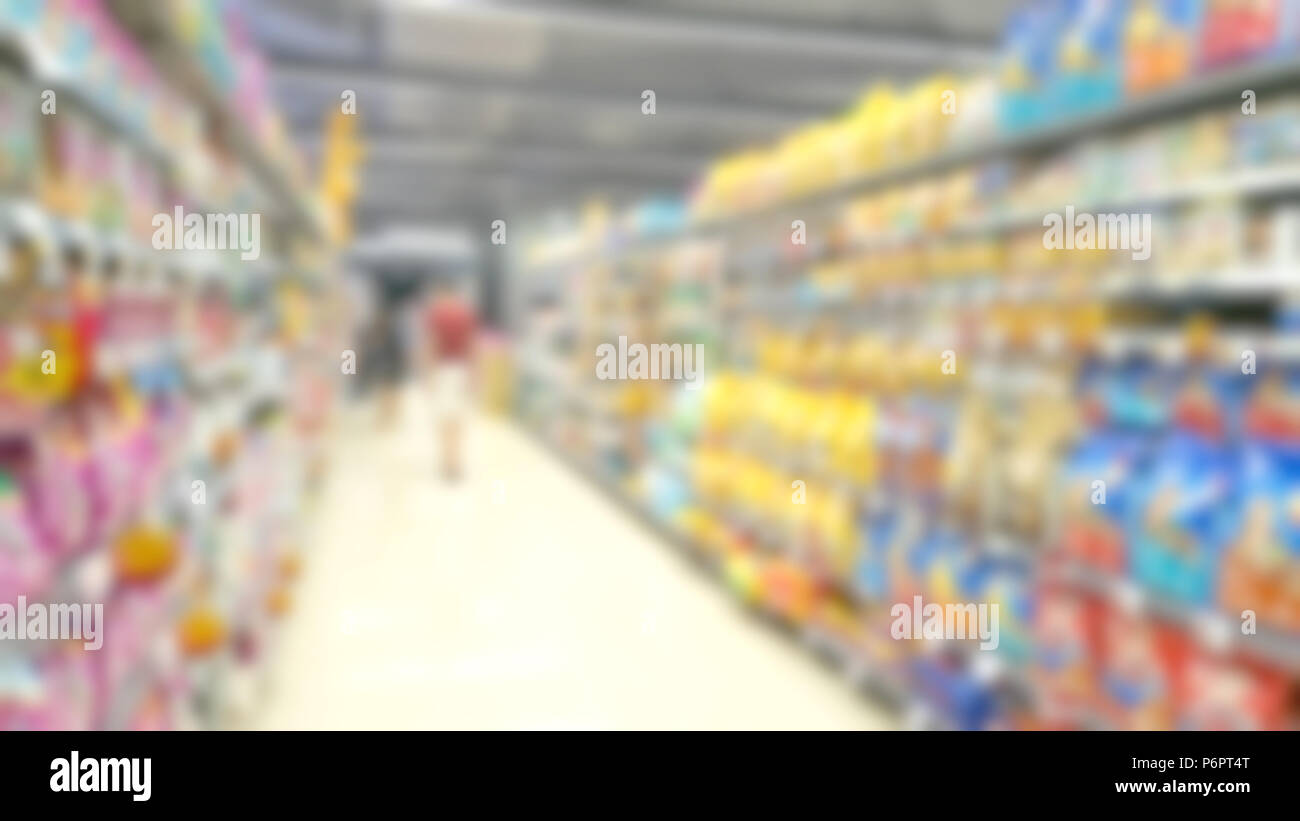 Abstract blur of aisle in supermarket with customers and department ...