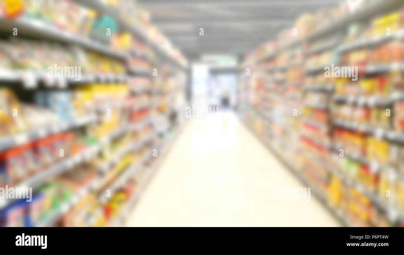 Abstract blur of aisle in supermarket with customers and department ...