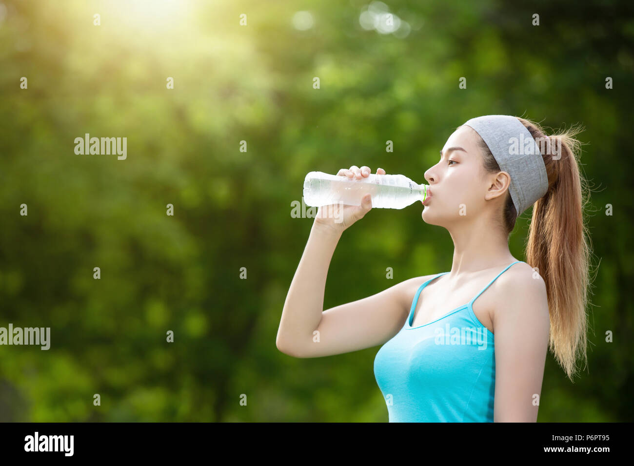 Girl drinking water exercise Stock Photo - Alamy
