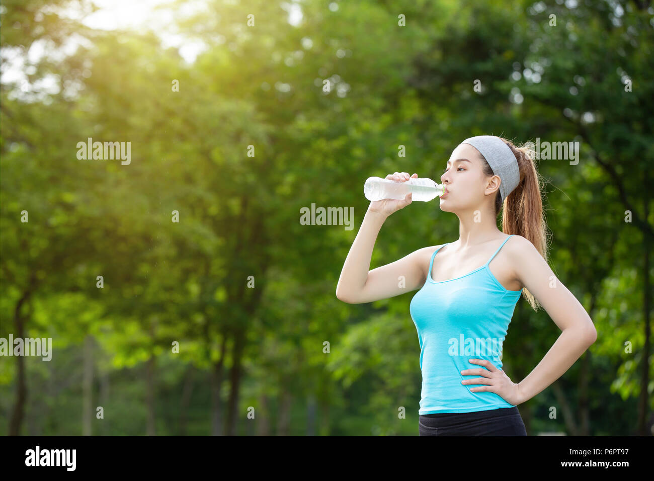 Girl drinking water exercise Stock Photo - Alamy