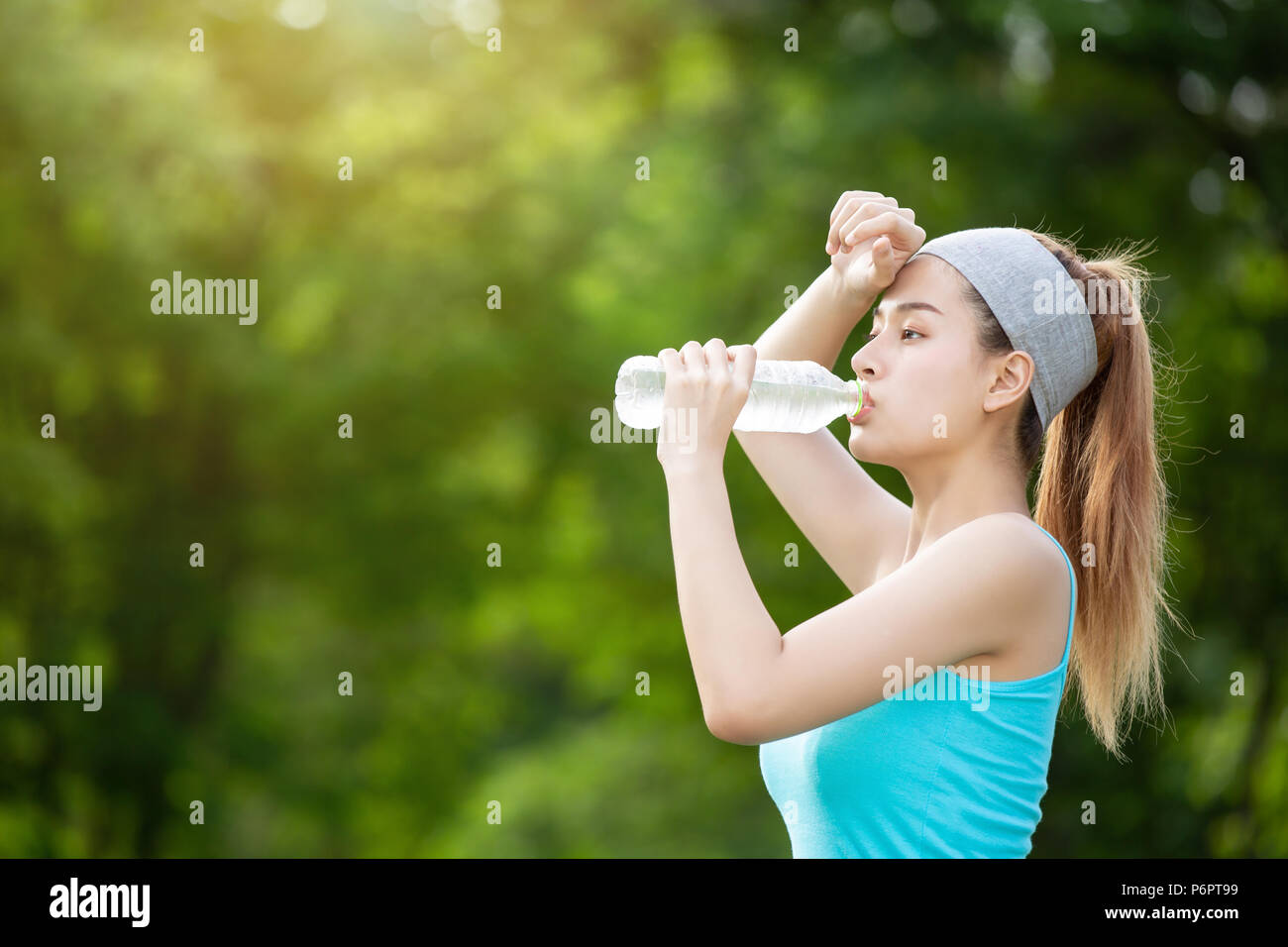 Girl drinking water exercise Stock Photo - Alamy