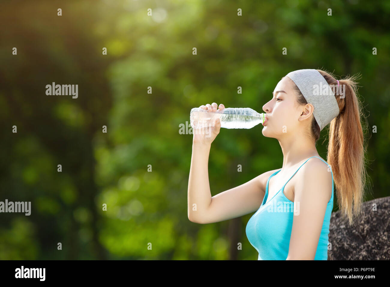 Girl drinking water exercise Stock Photo - Alamy