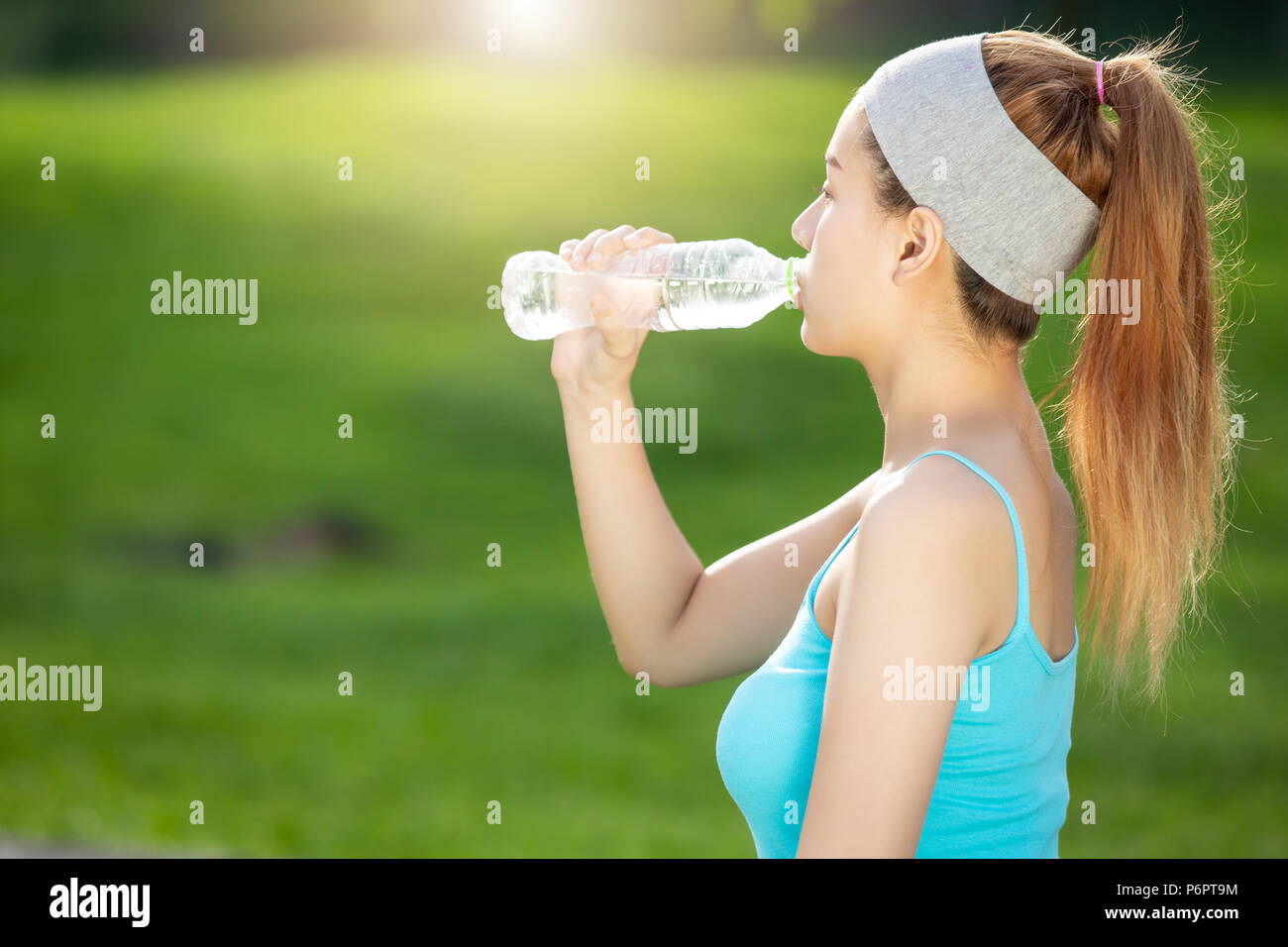 Girl drinking water exercise Stock Photo - Alamy