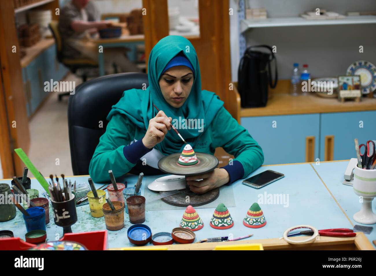 Gaza. 2nd July, 2018. A Palestinian deaf woman paints on a piece of ...