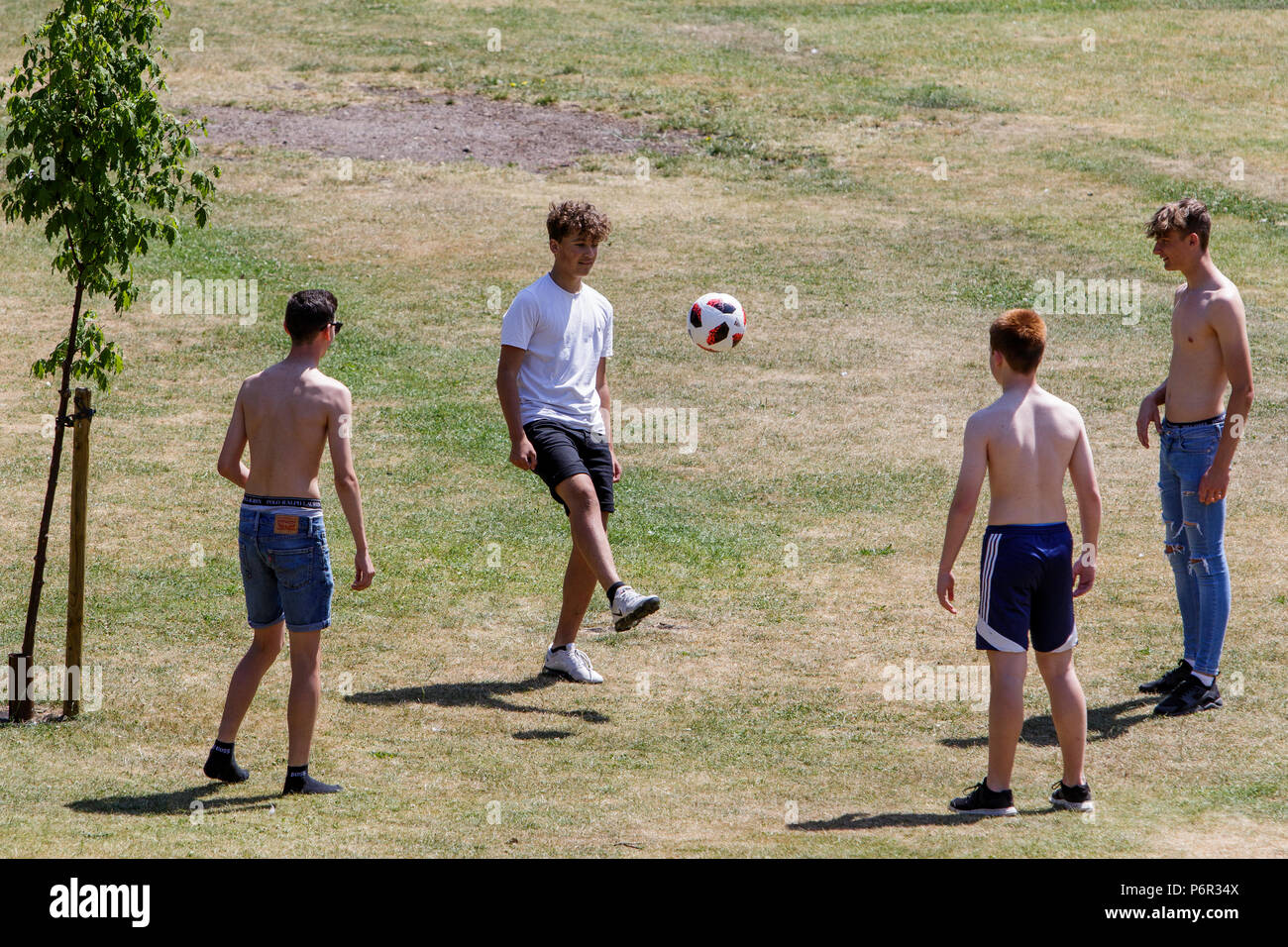 Boy playing football in england hi-res stock photography and images - Alamy