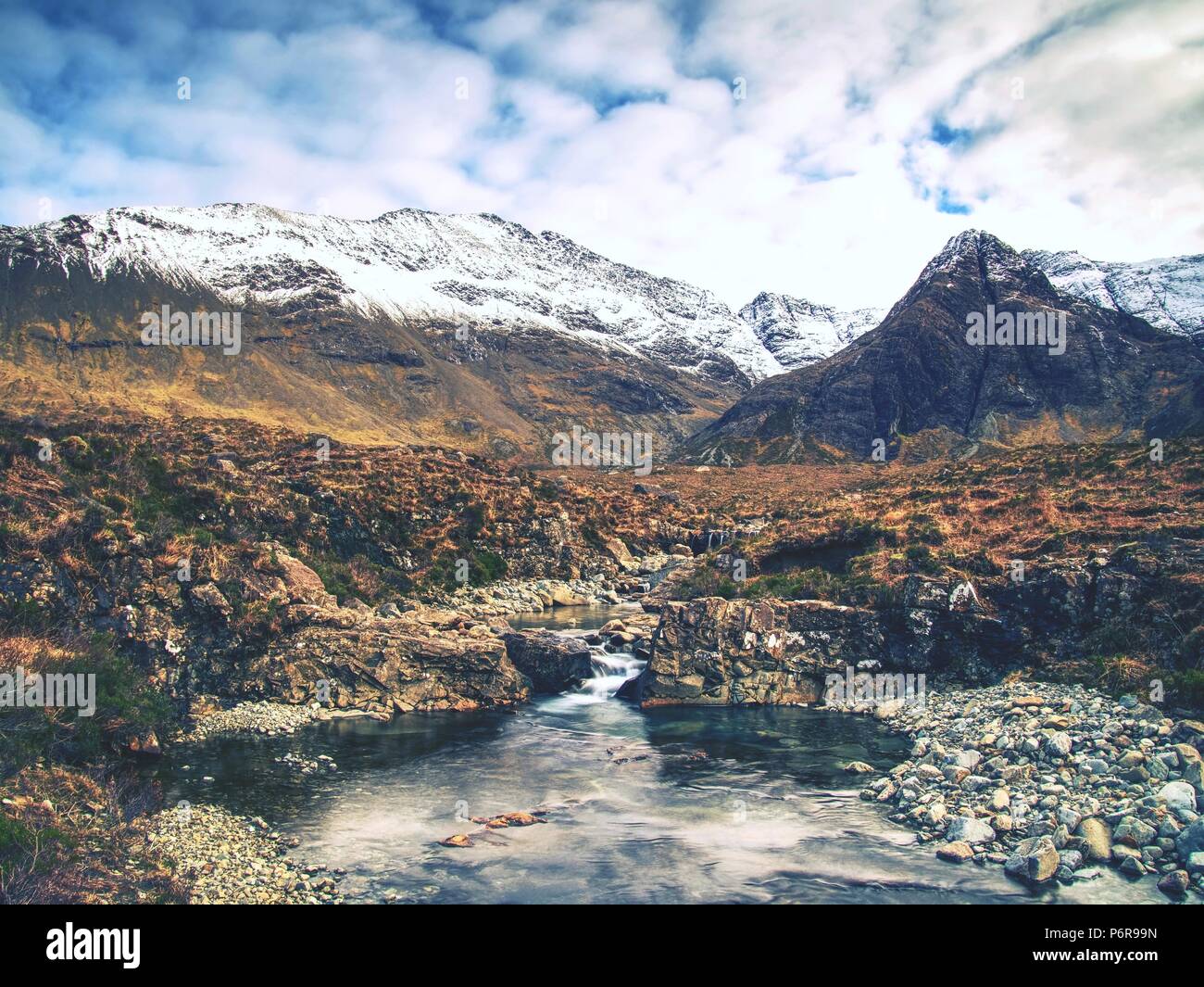 Pools and waterfalls within cloudy day in Scotland. Cold water falling ...