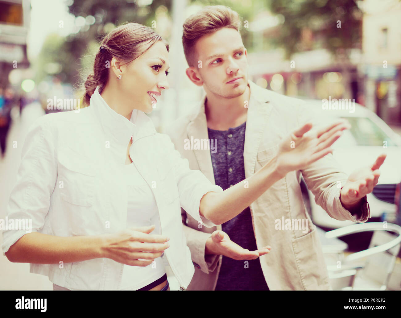Young traveller asking woman direction at the street Stock Photo - Alamy