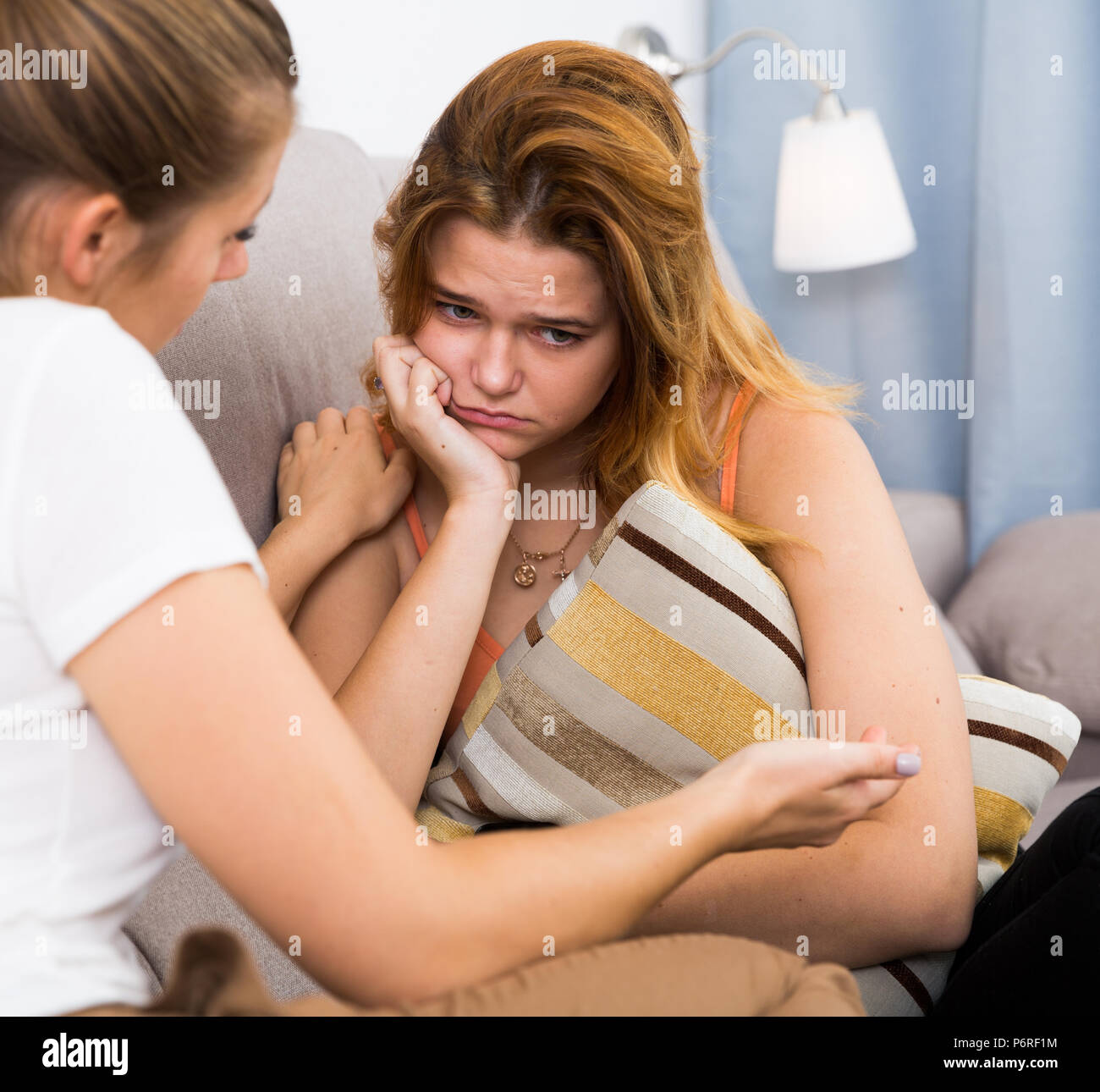 Young girl is comforting her sad girlfriend at her home Stock Photo - Alamy