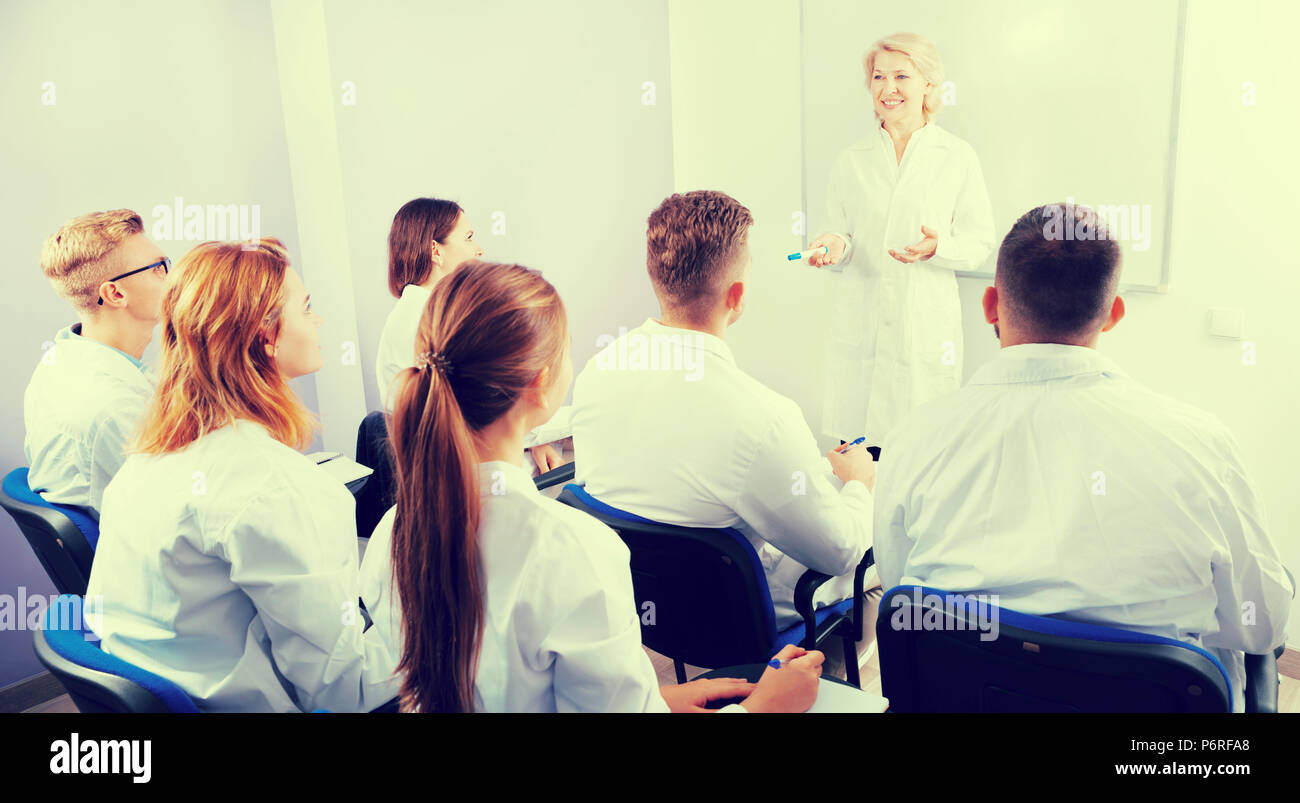 Female professor giving presentation for medical students in lecture ...