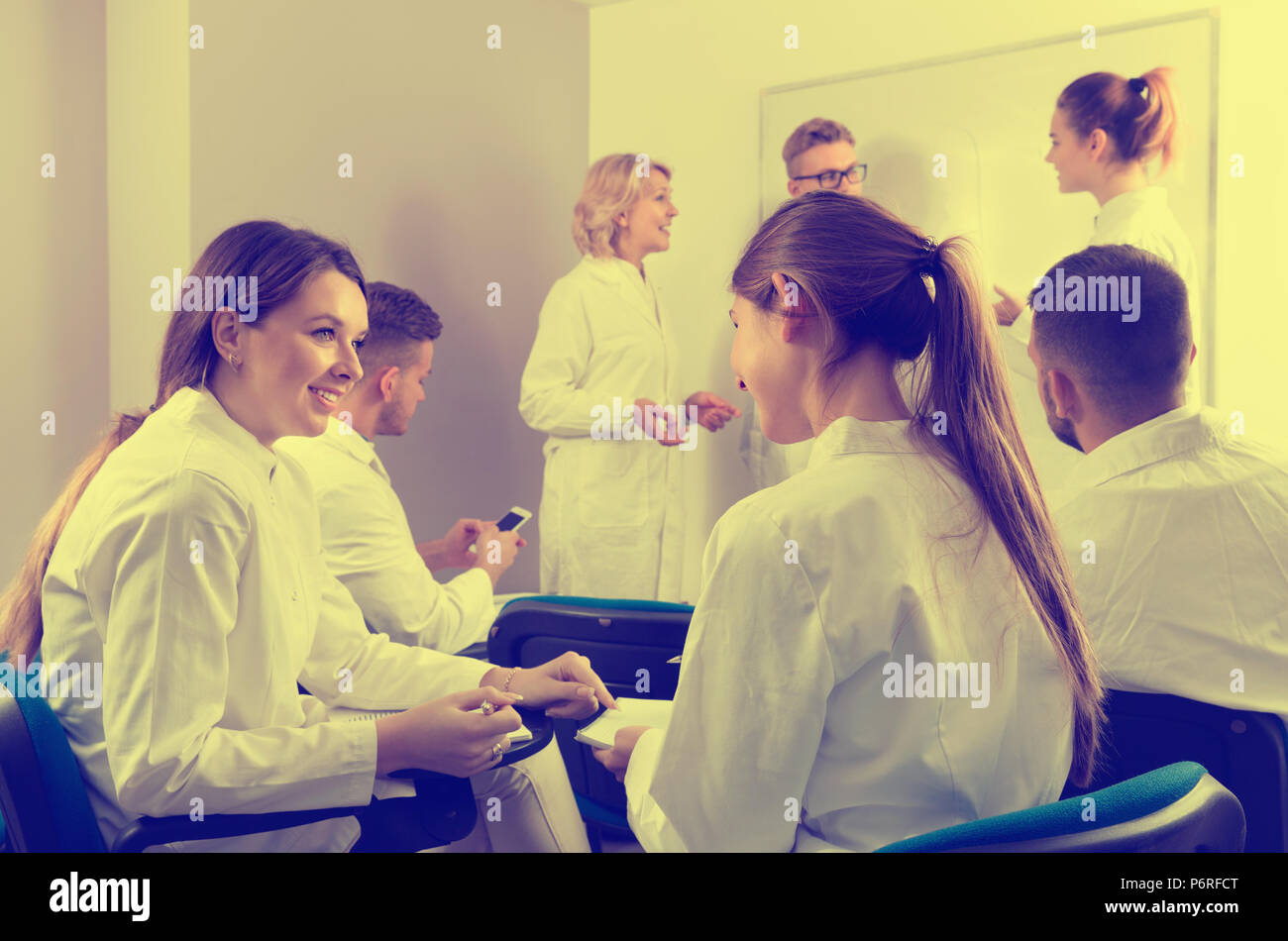 Happy cheerful medical students communicating during recess between ...