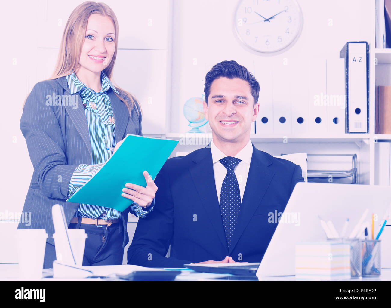 Elegant business woman writing down tasks of chief man at table Stock ...