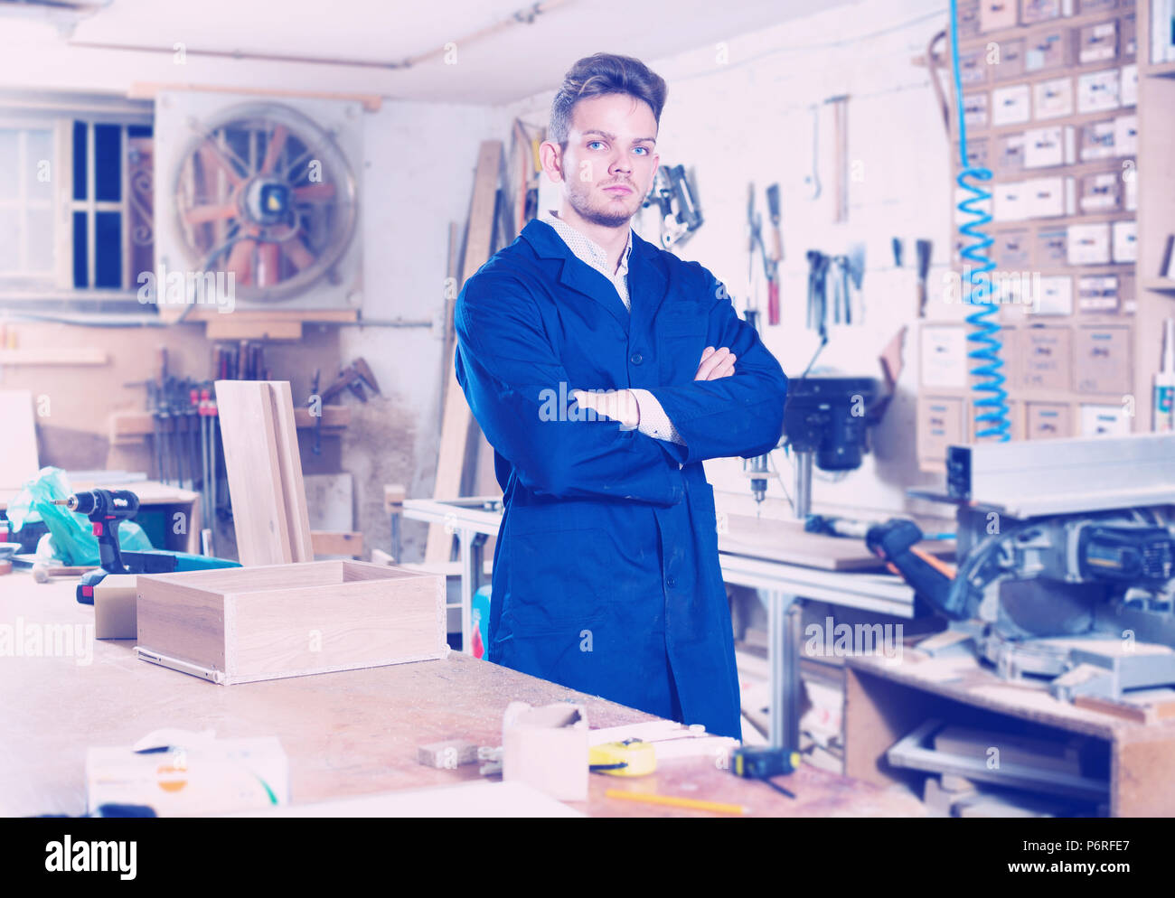 Young male joiner standing at his workplace with tools Stock Photo - Alamy