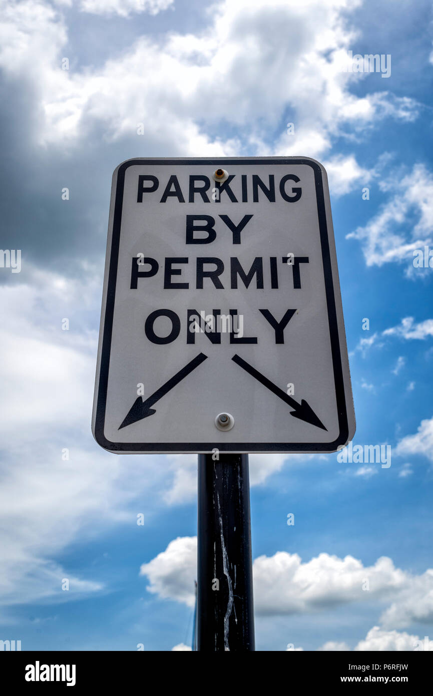 Parking by permit only sign by parking bays Stock Photo - Alamy