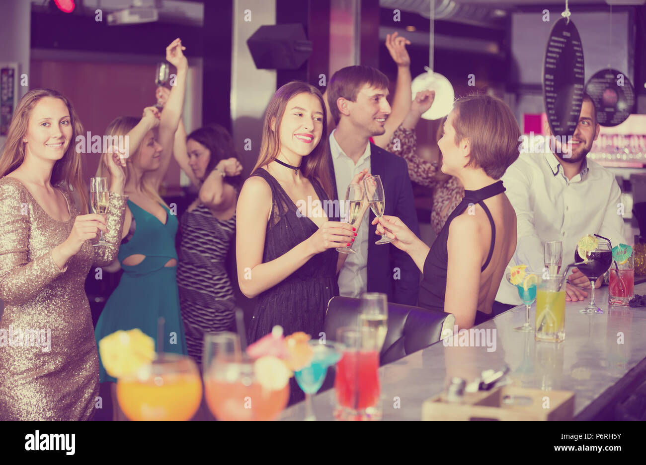 Happy colleagues dancing on corporate party with alcohol in hands Stock ...