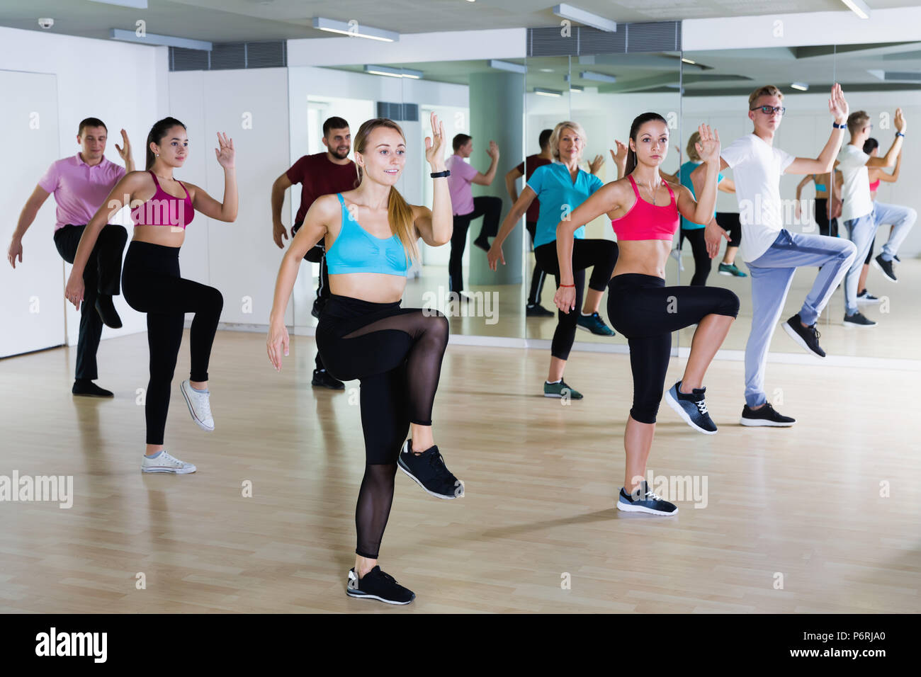 Positive people of different ages dancing in dance school Stock Photo ...