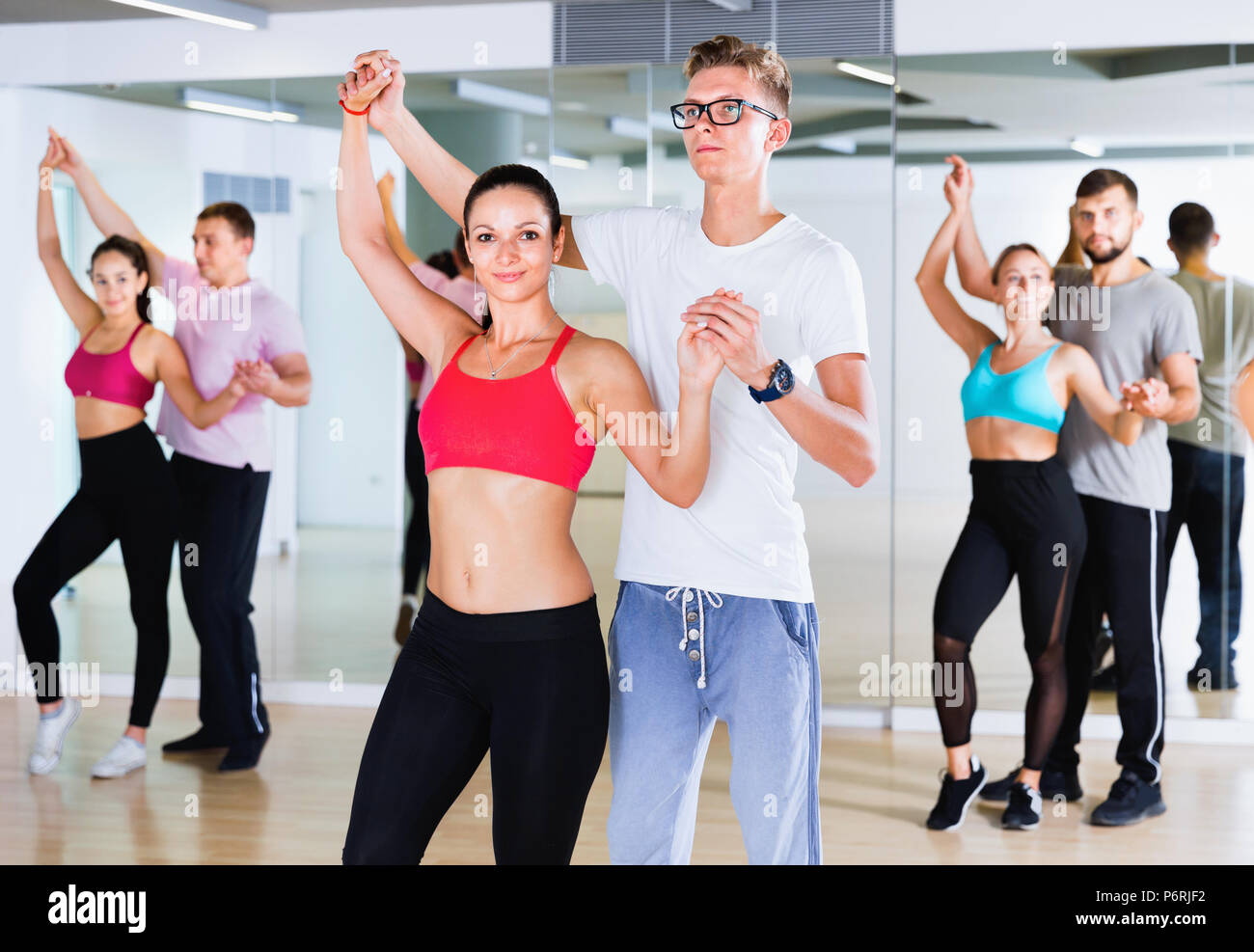 Happy people of different ages having dancing class in classroom Stock ...