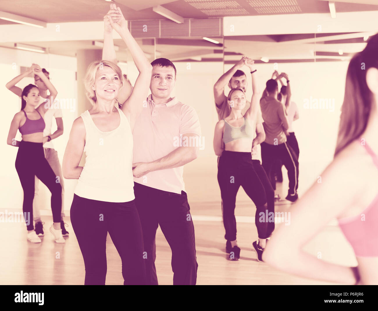 happy french men and women of different ages dancing salsa in dance ...