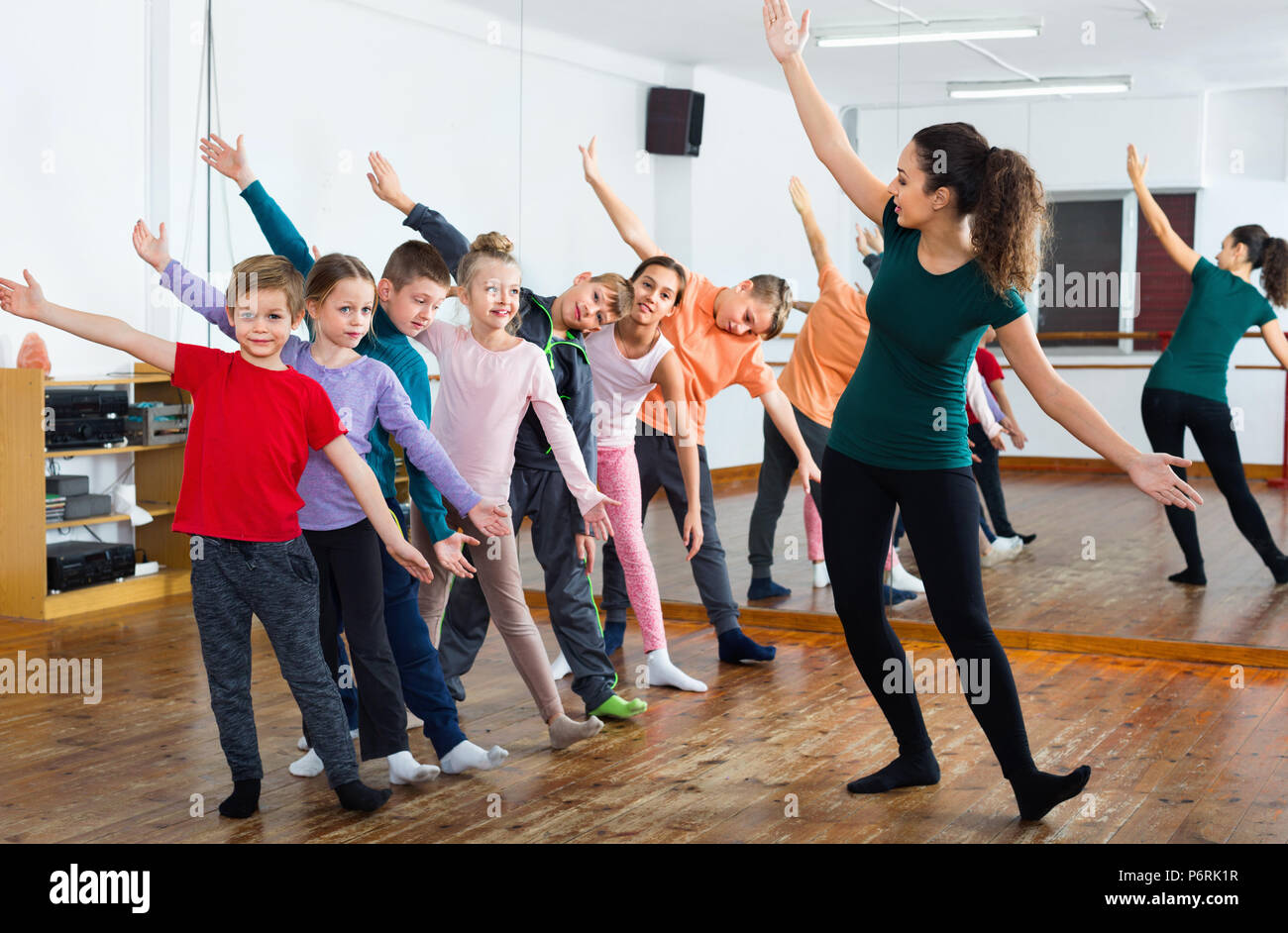 Happy positive children dancing contemp in studio smiling and having ...