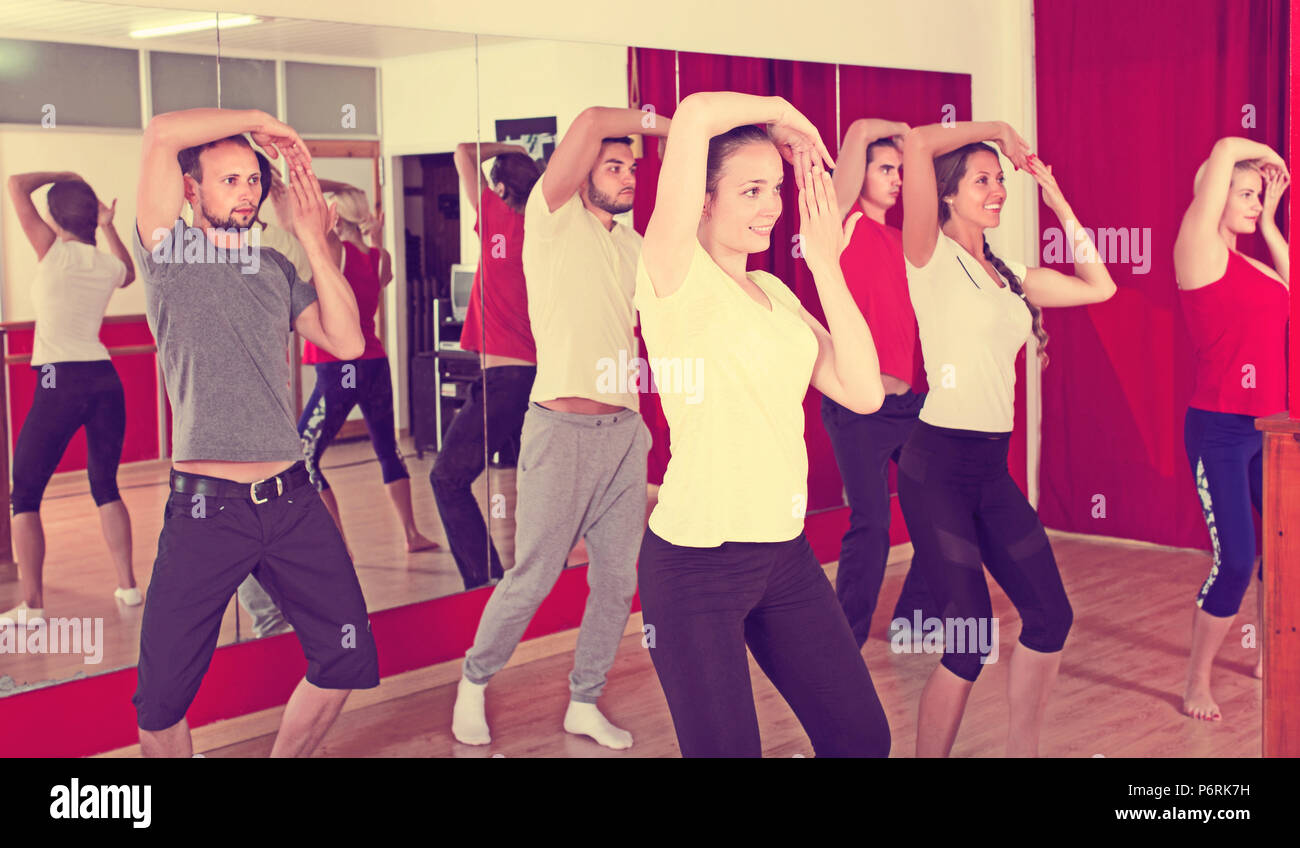 Active smiling young couples dancing modern style dance in class Stock ...