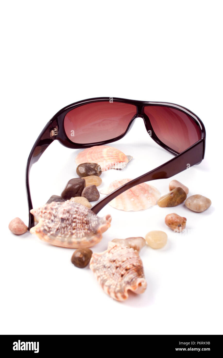 sunglasses, shells and pebbles closeup on white background Stock Photo ...