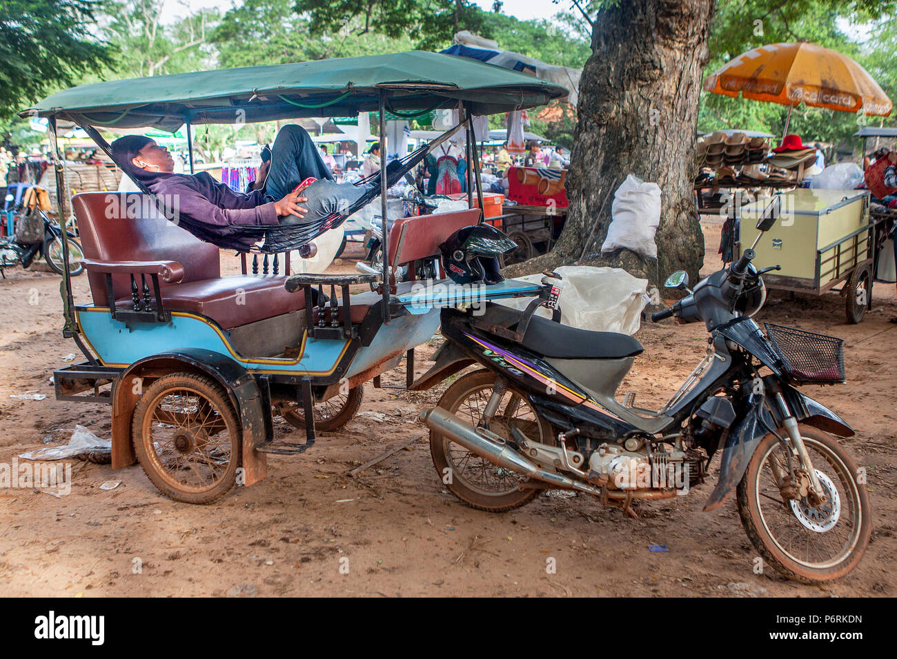 Asian motorcycle taxi man with his motorcycle on the asphalt road Stock ...