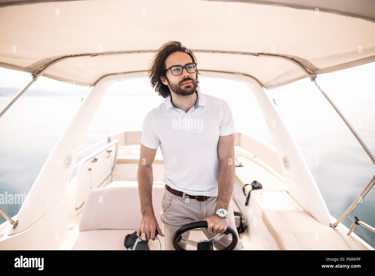 Old man driving boat hi-res stock photography and images - Alamy