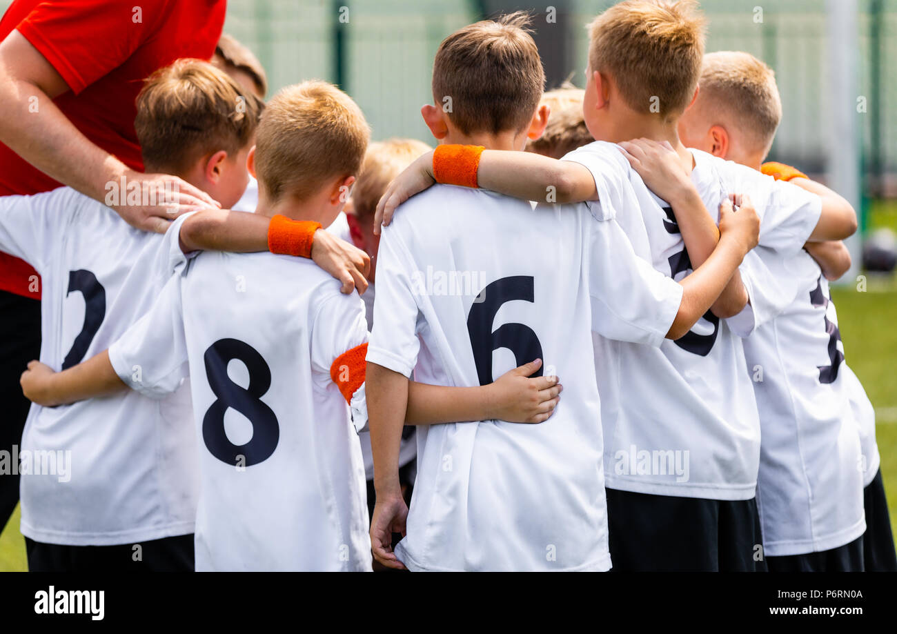 Youth sports team huddle with coach. Boys having motivational talk with ...