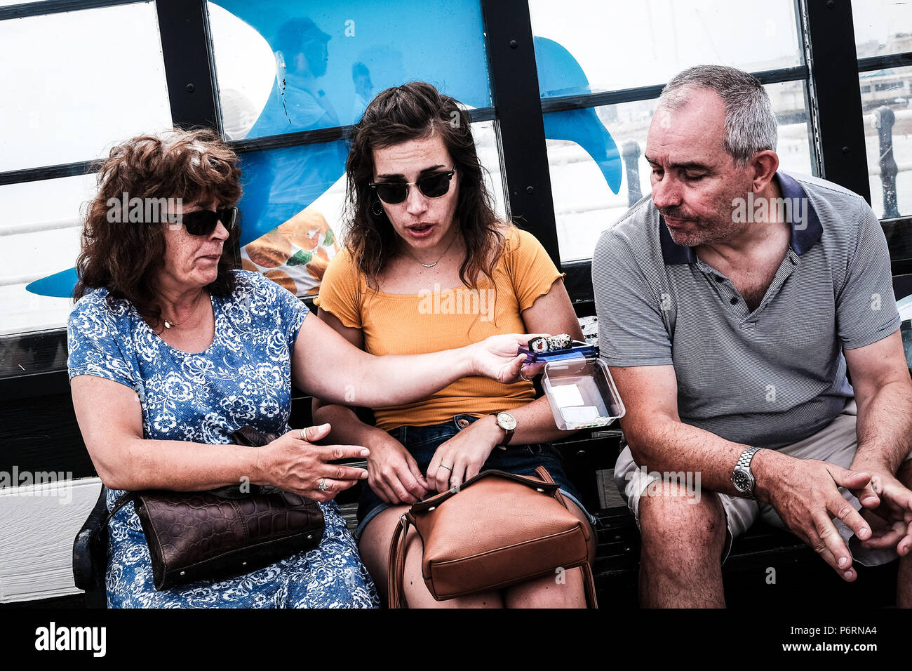 British Seaside life - A typical seaside pier scene - a family share a ...