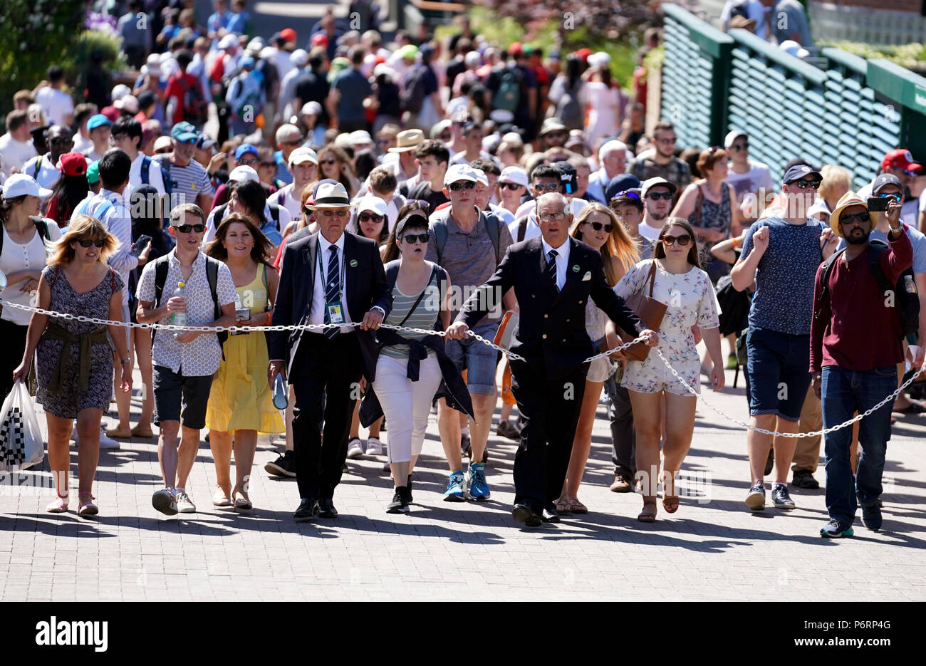 Spectators are led into the grounds on day one of the Wimbledon ...