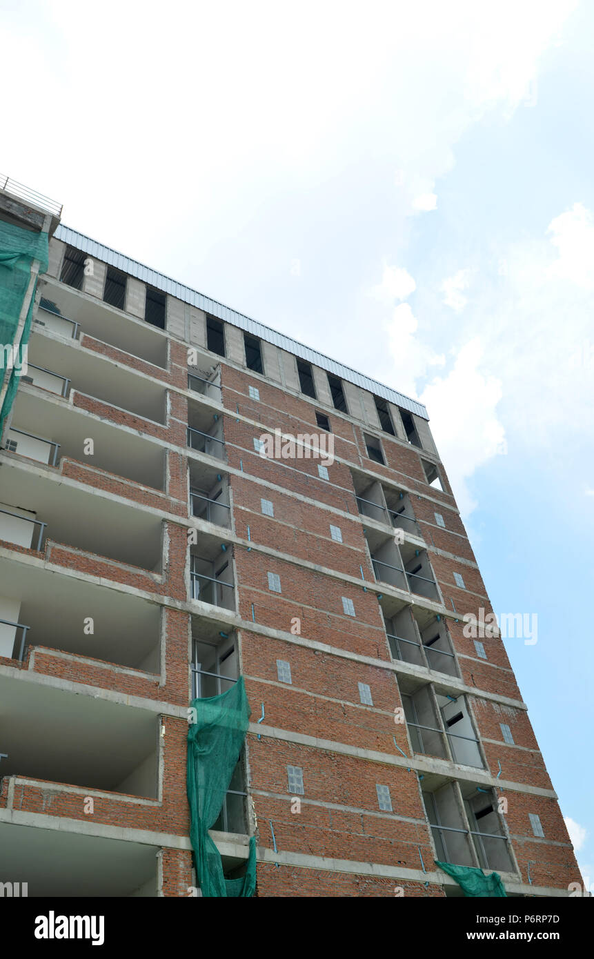 Low-angle view of a tall commercial building under construction against ...