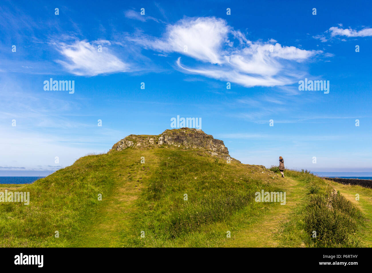Lone woman walks on dedicated path on he Holy Island of Lindisfarne ...