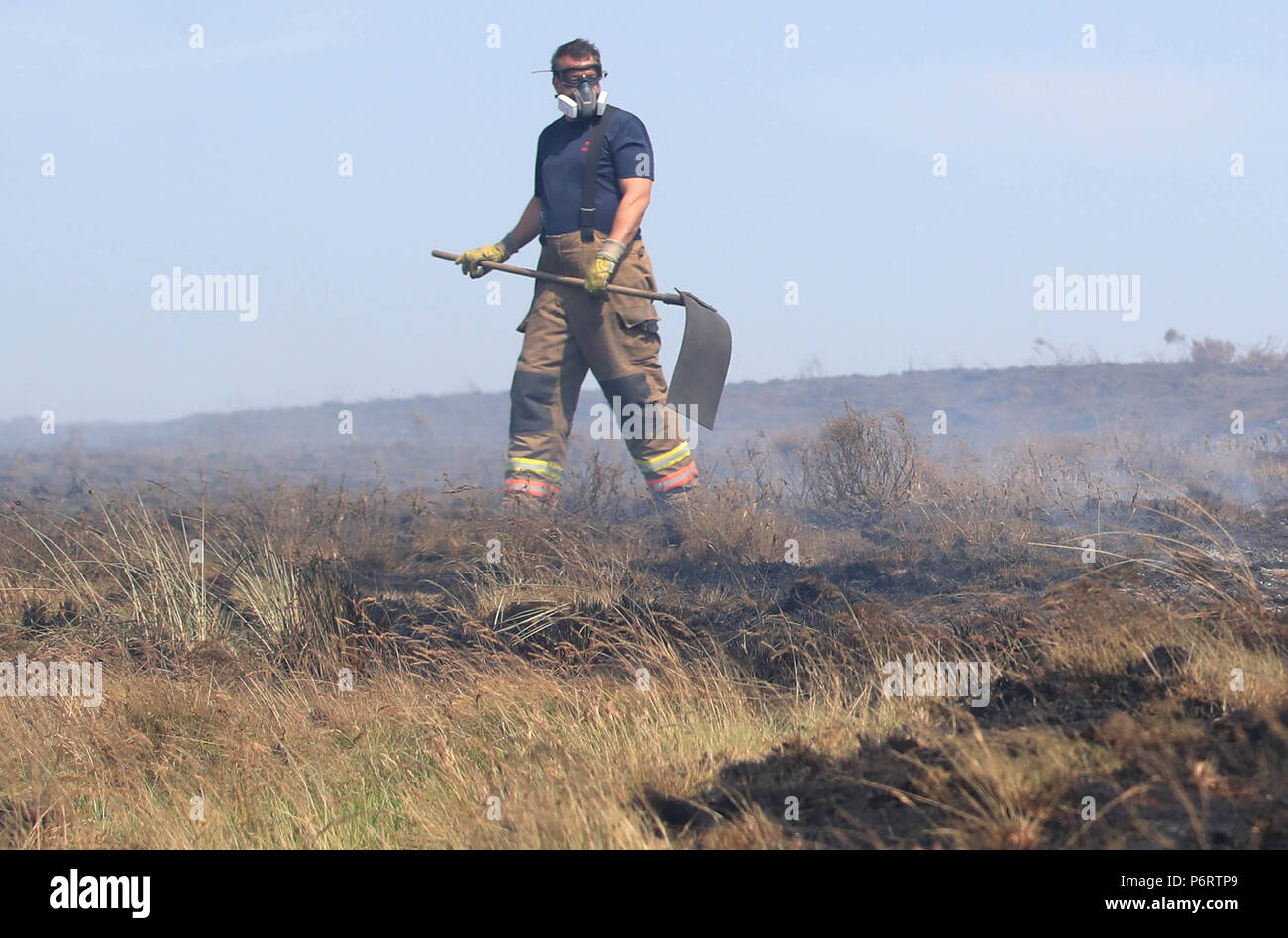 A firefighter from Tyne and Wear Fire and Rescue Service puts out the ...