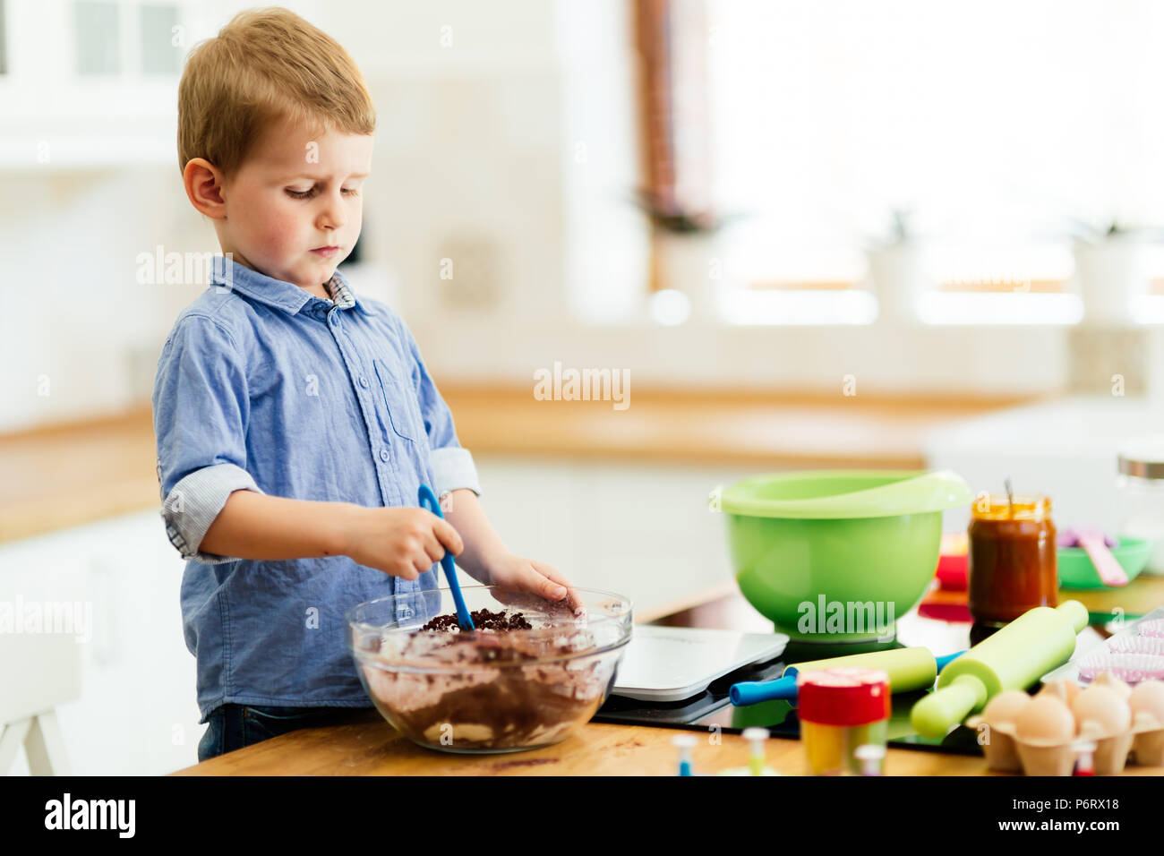 Cute child learning to become a chef Stock Photo - Alamy