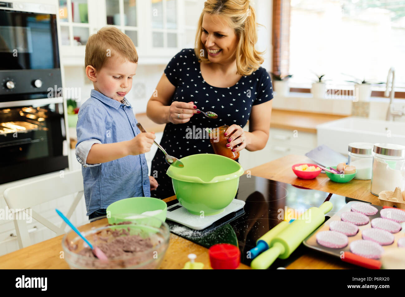 Child helping mother bake cookies Stock Photo - Alamy