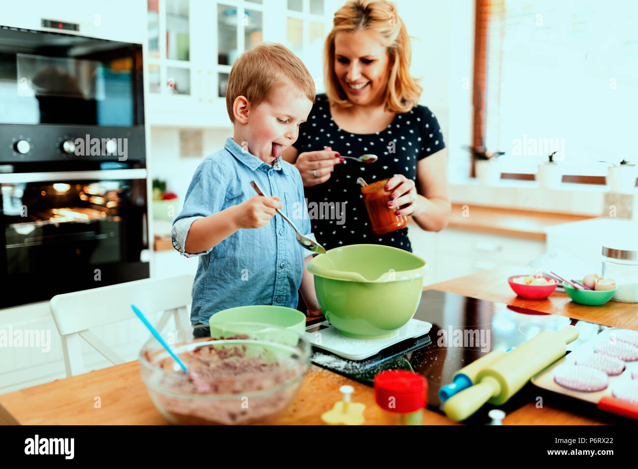 Beautiful child and mother baking Stock Photo - Alamy