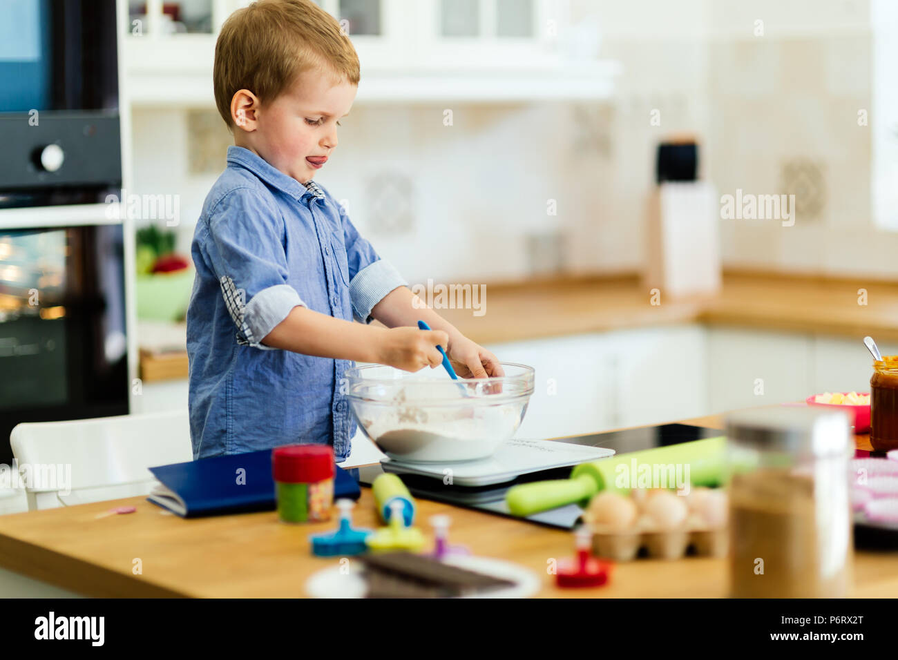 Cute child learning to become a chef Stock Photo - Alamy Cute child learning to become a chef Stock Photo - Alamy