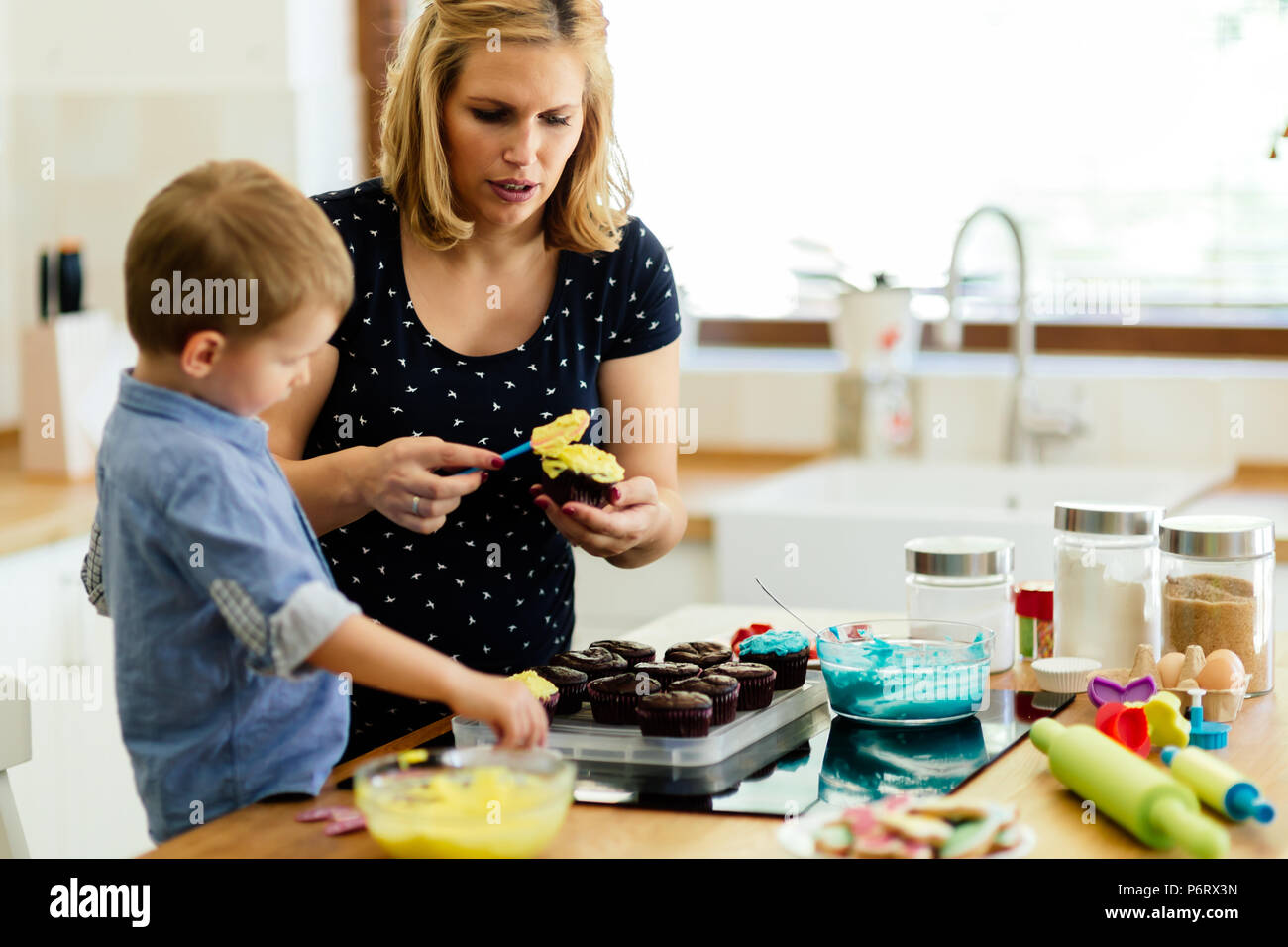 Child helping mother bake cookies Stock Photo - Alamy