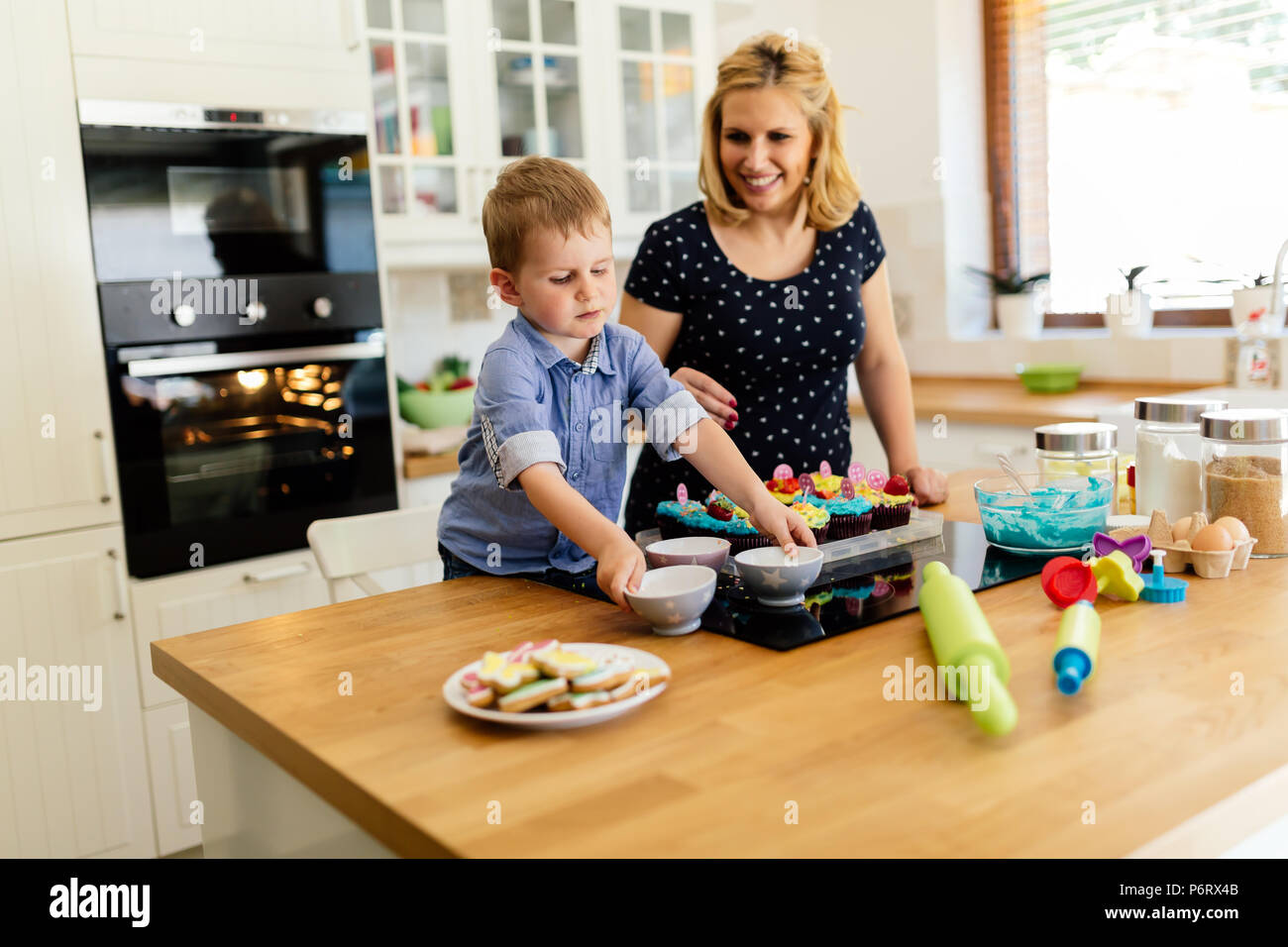 Beautiful child and mother baking Stock Photo - Alamy