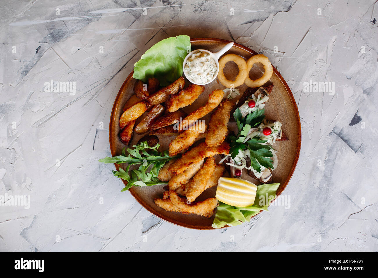 Clay plate full of delicious appetizers Stock Photo - Alamy