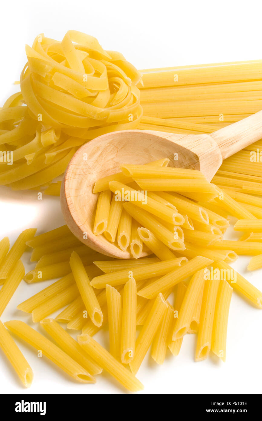 raw italian pasta in wooden spoon on white background Stock Photo - Alamy