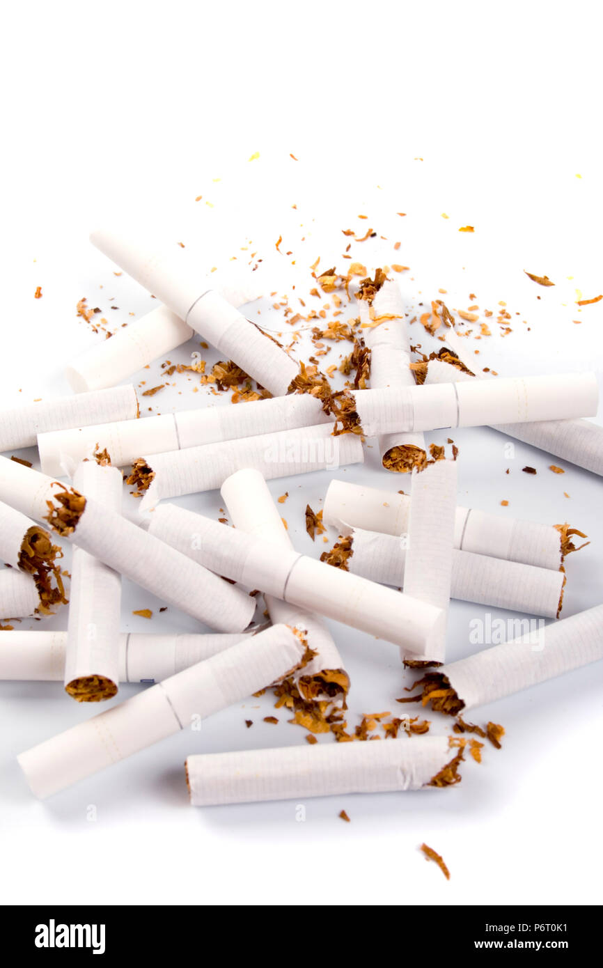 broken cigarettes closeup on white background Stock Photo - Alamy