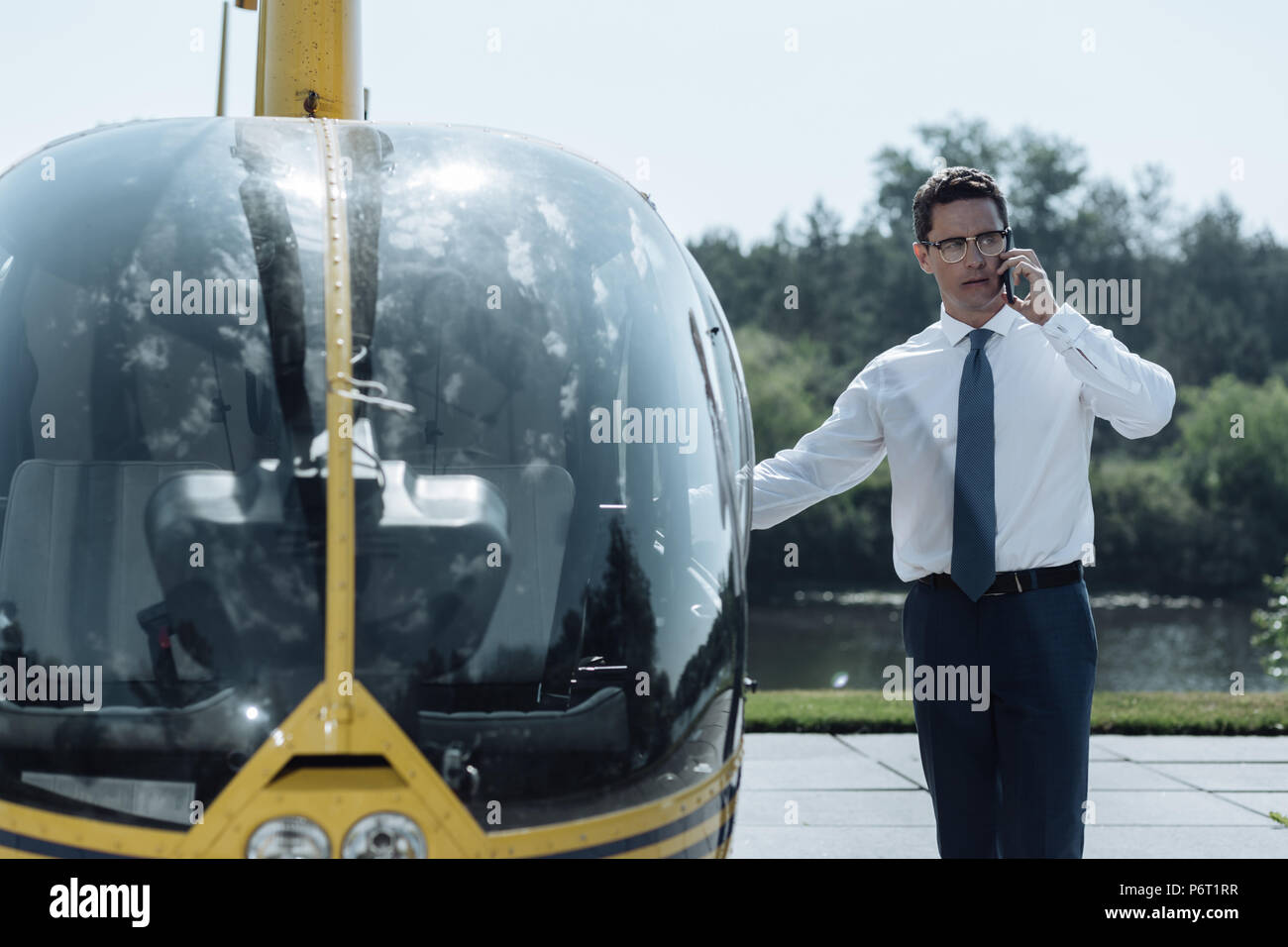 Young police officer opening helicopter door Stock Photo - Alamy