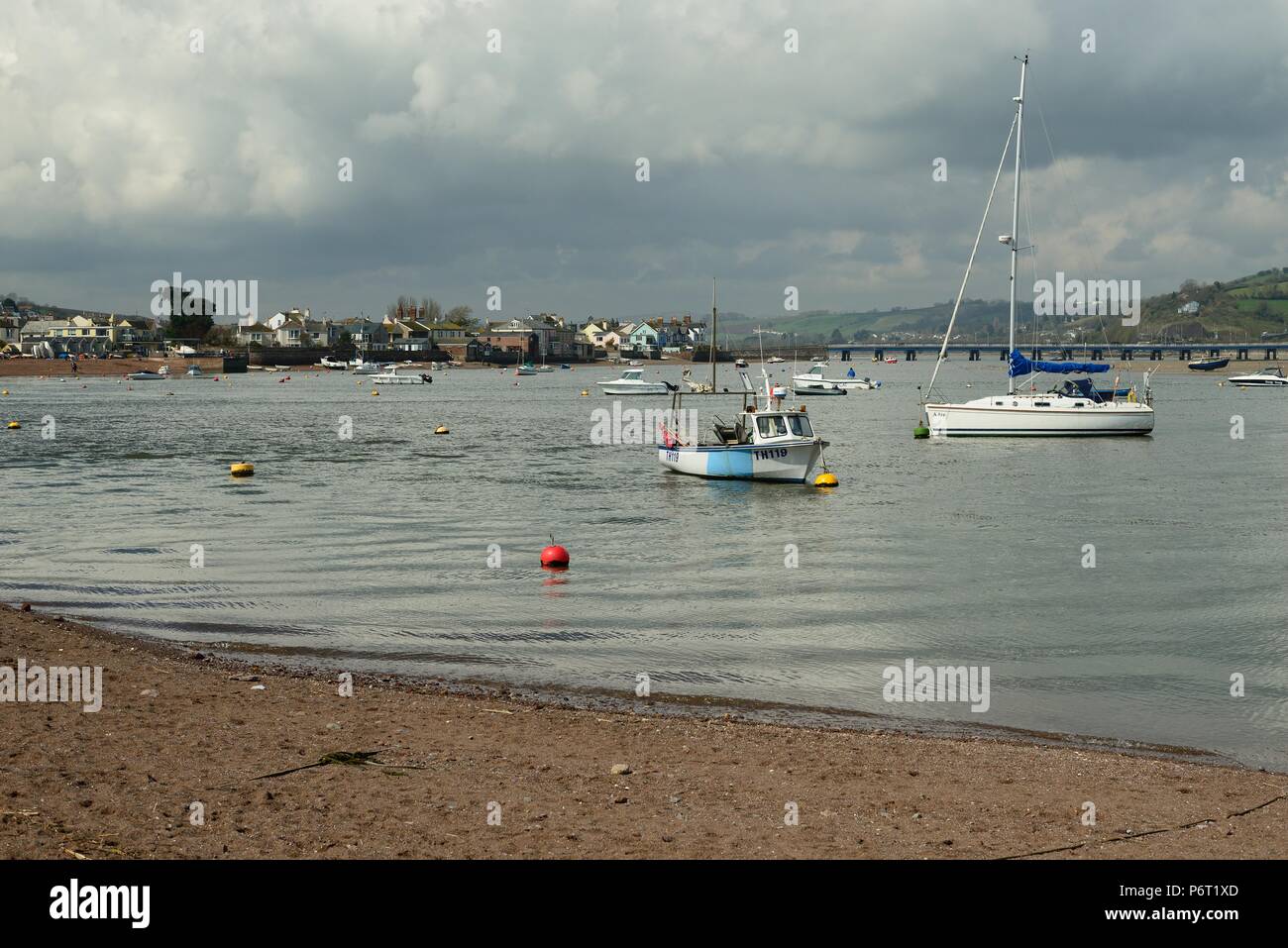Boats moored in the Teign estuary at Teignmouth, with Shaldon bridge ...
